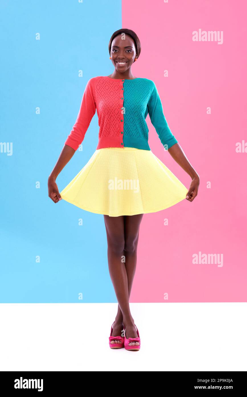 Colorful curtsy. Studio portrait of an attractive woman curtsying in ...