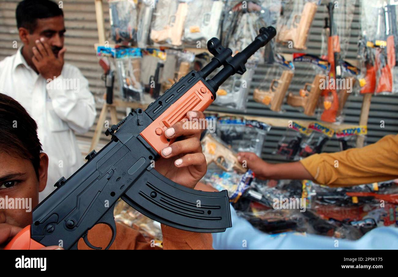 A Pakistani boy shows his toy weapon during Eid al-Fitr celebrations in ...