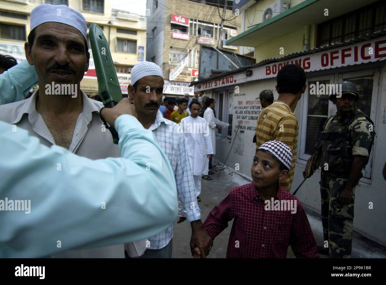 Security personnel frisk Muslim devotees before entering a mosque in ...