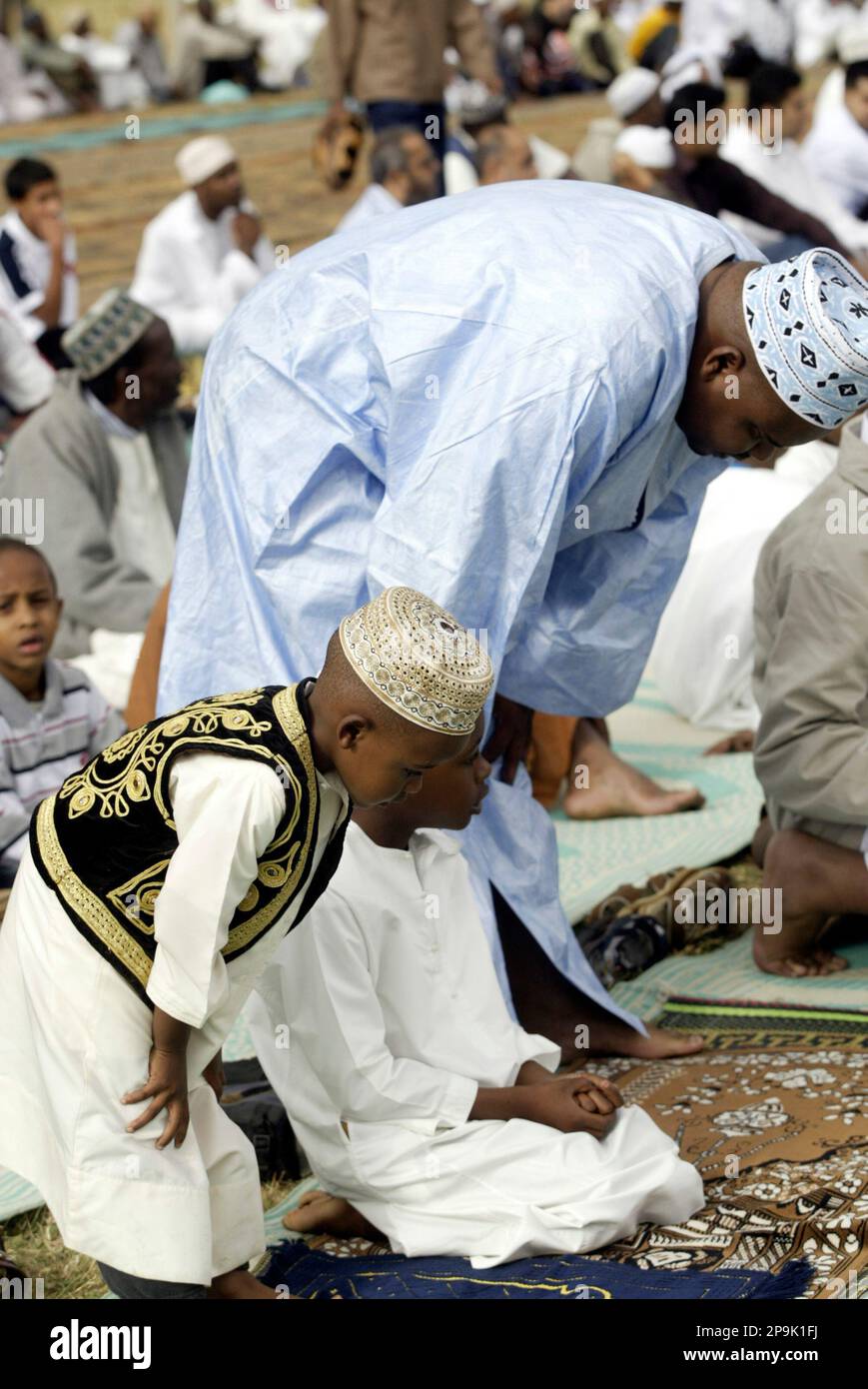 A Kenyan muslim offers prayers with his child in Nairobi, Kenyan ...