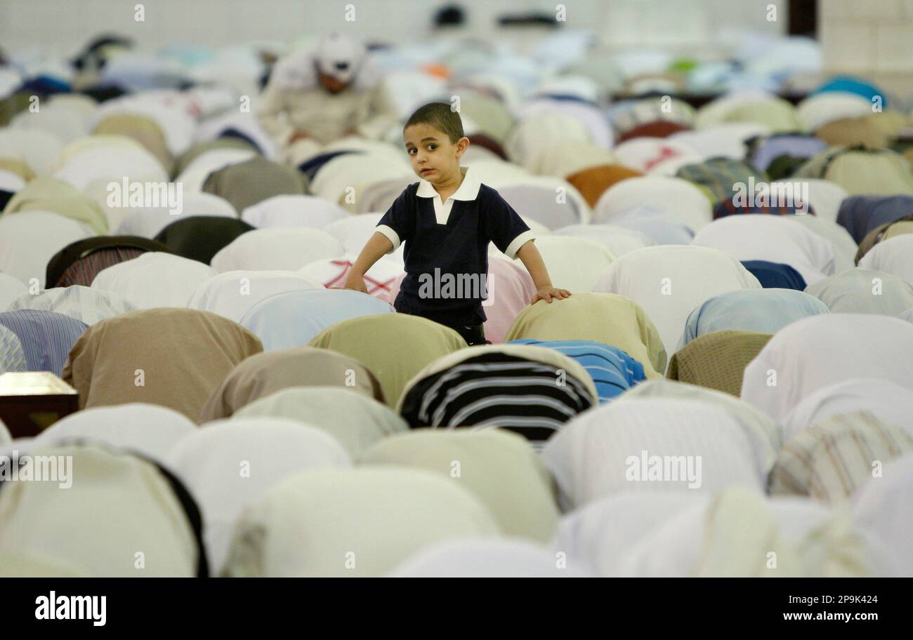 A child watch Saudi men praying at the Imam Turki bin Abdullah mosque ...