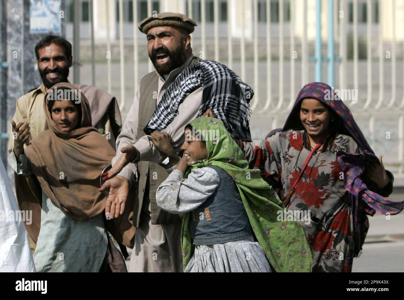 An Afghan man shouts as begger ask for money outside Eid Gah mosque in ...