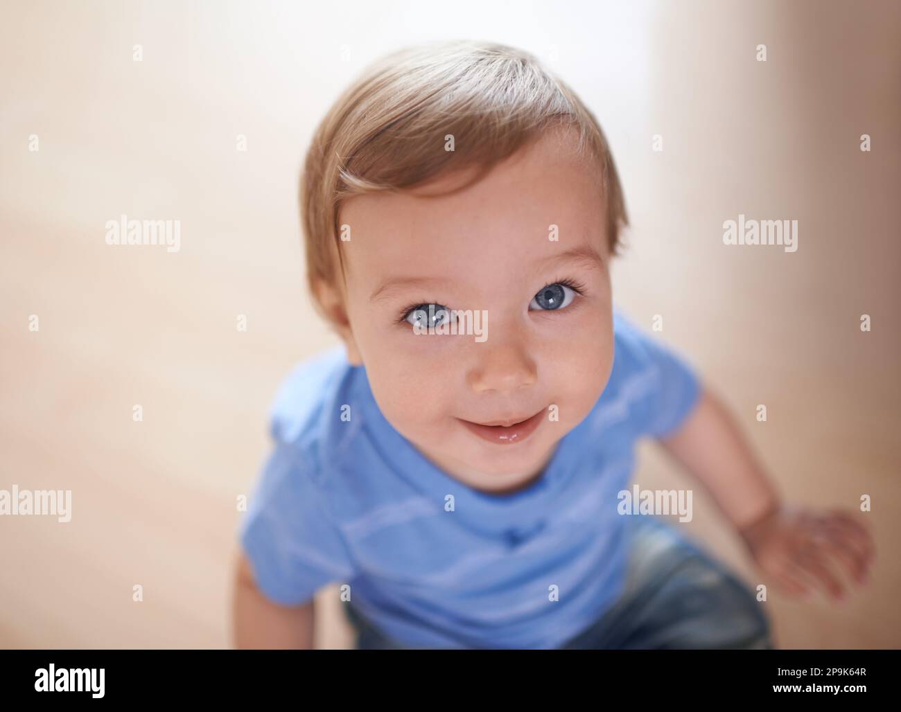The cutest smile. an adorable little infant looking up at the camera ...