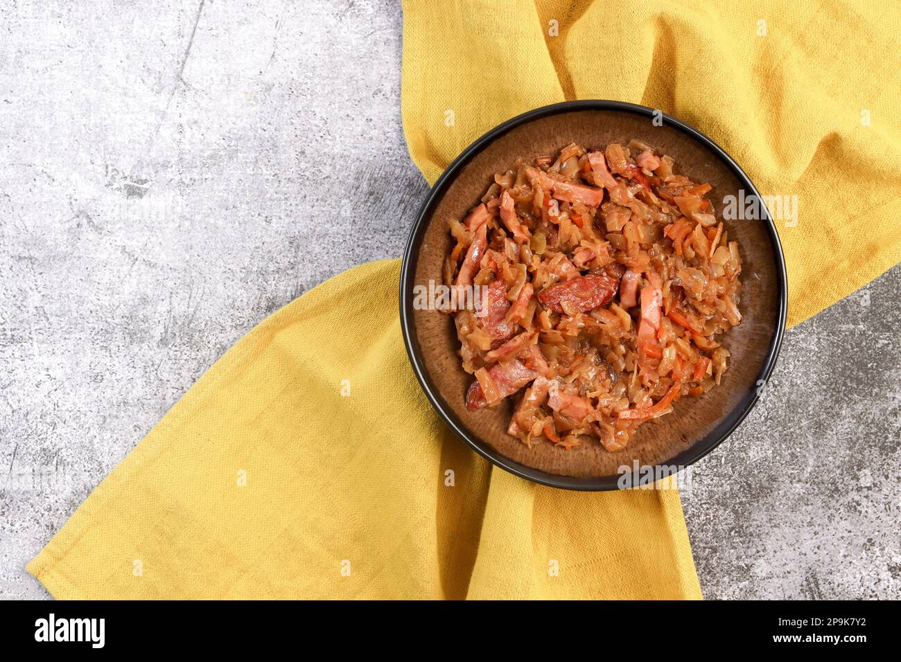 Traditional Polish dish Bigos Stew in a bowl on a dark background. Top ...