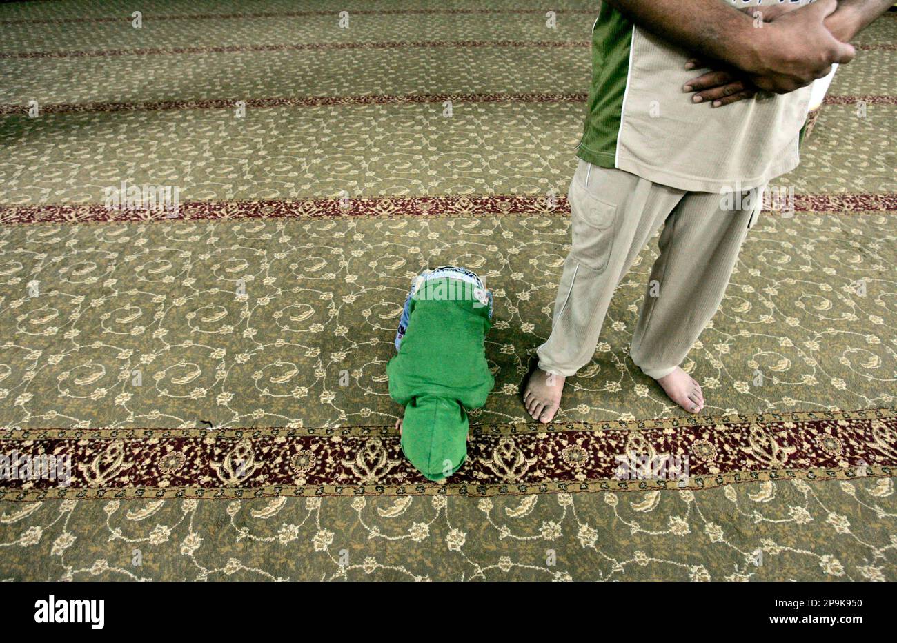 A Palestinian Muslim man and his son, pray on "fajr" or early morning ...