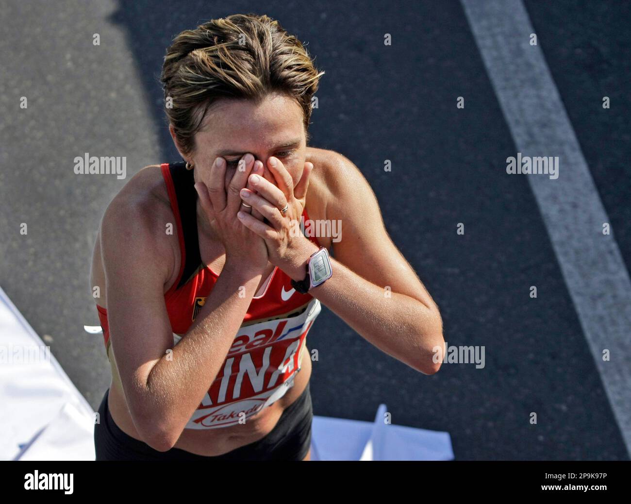 Irina Mikitenko from Germany reacts after crossing the finish line to ...