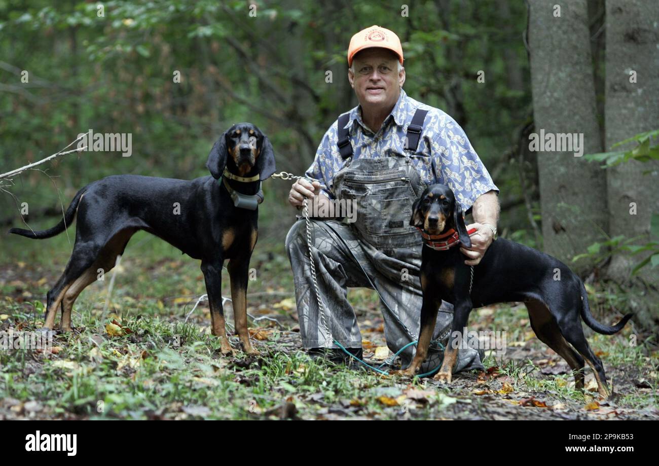 Retired veterinarian David Birdsall poses with two of his Black and Tan ...