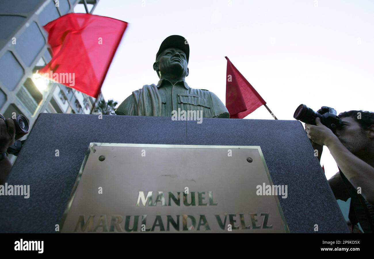Photographers takes pictures of a bust of the late Manuel Marulanda ...