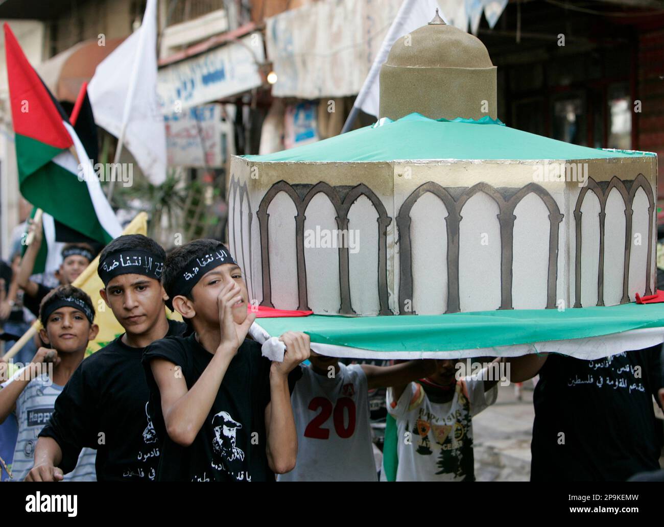 Palestinian children carry a representation of Al Aqsa Mosque during a ...