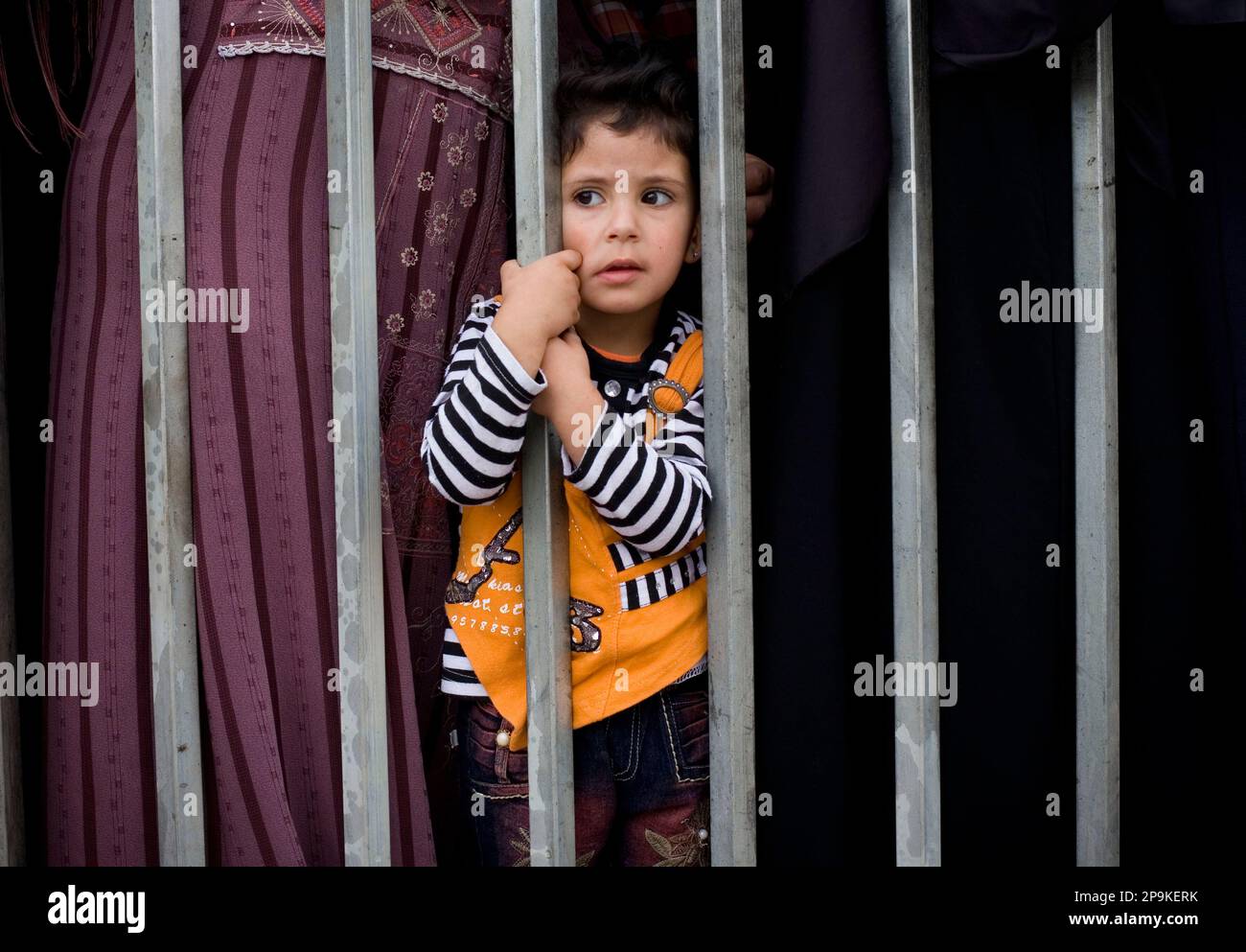 A Palestinian child waits to cross a checkpoint on the way to pray for ...