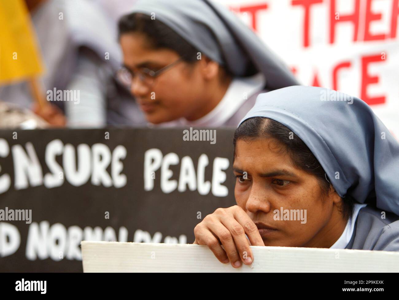 Christian nuns sit at a protest against recent incidents of people from ...