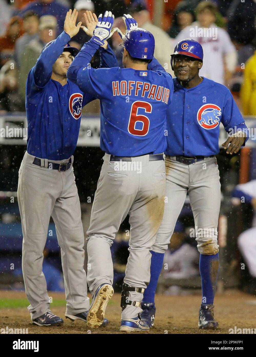 Chicago Cubs' Ryan Theriot, left, and Felix Pie, right, greet Micah ...