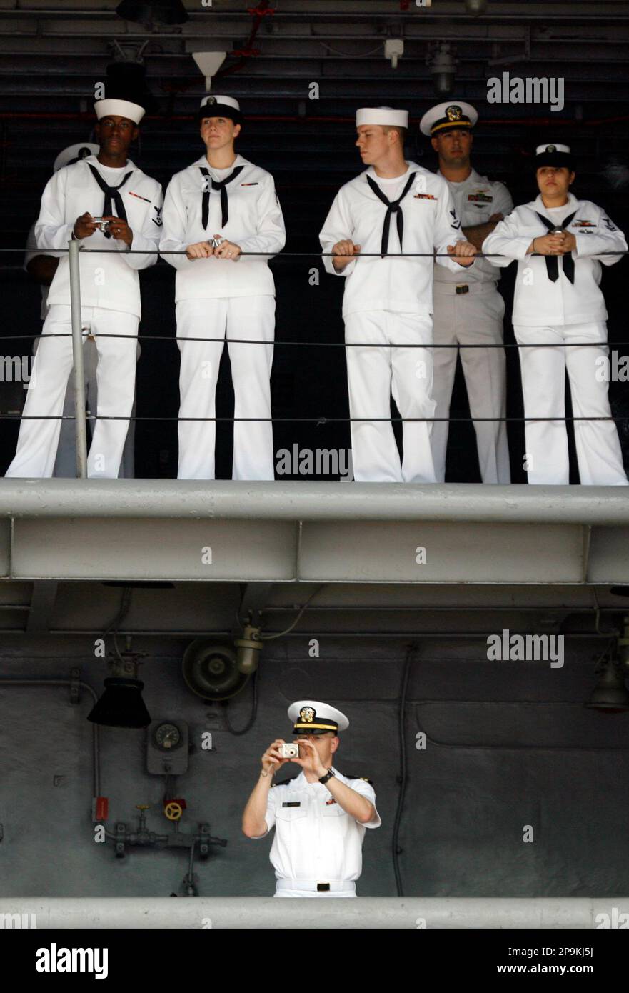 Crew members of the U.S. navy nuclear-powered aircraft carrier USS ...