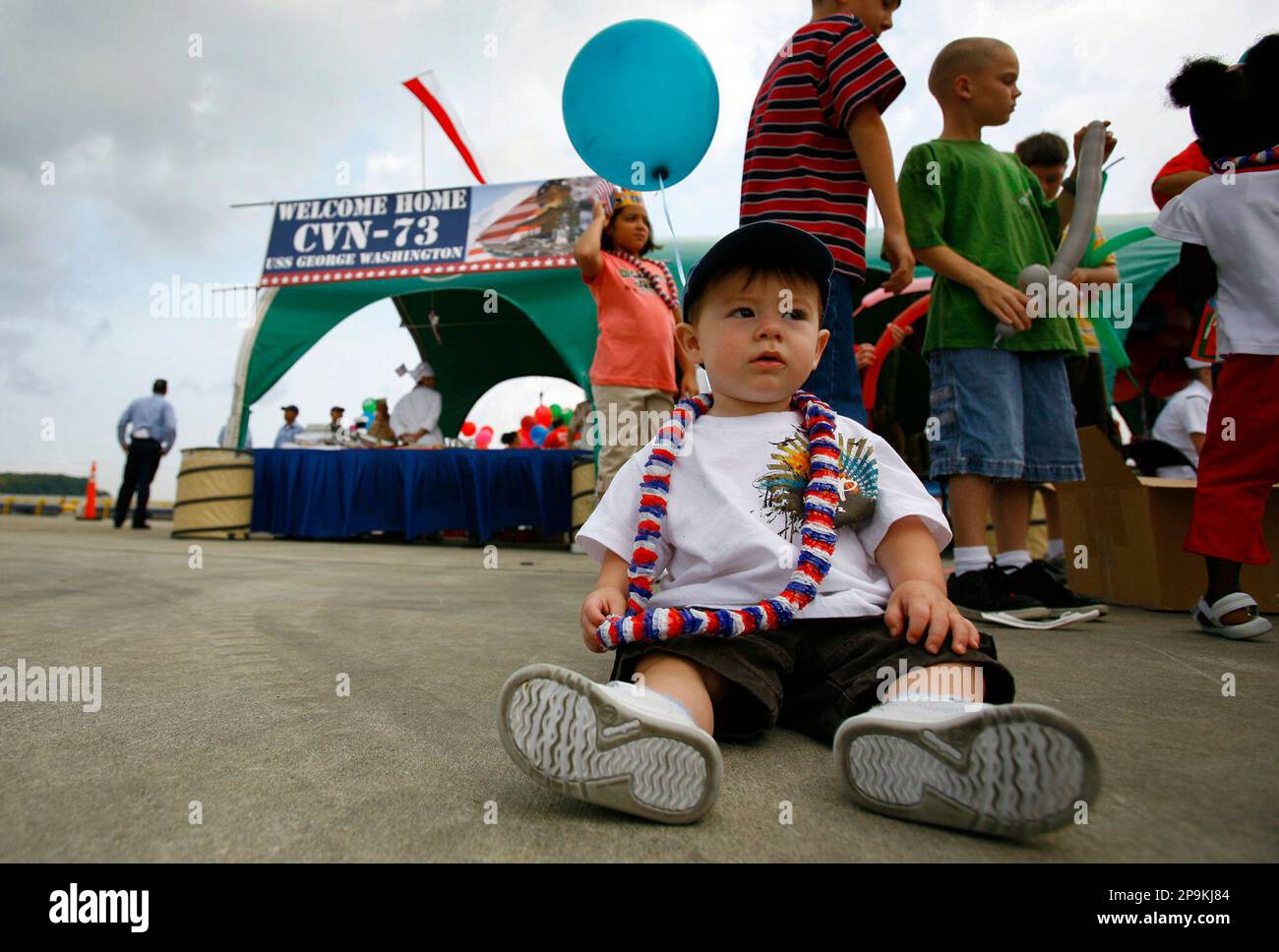 William Scanlon, 1, of Chicago, sits on a pier ground awaiting for U.S ...