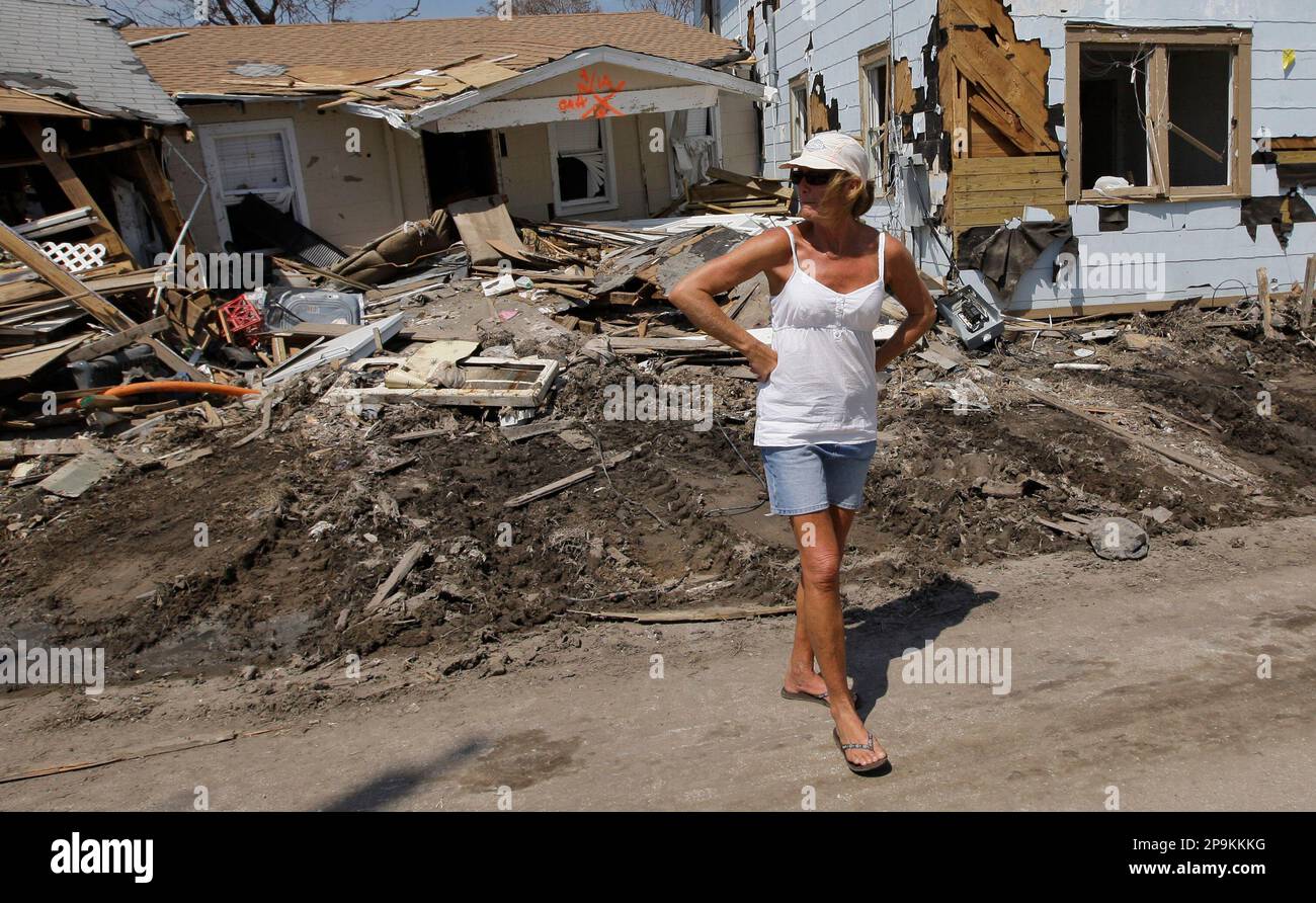 Donna Hanson pauses as she walks through her damaged neighborhood in ...