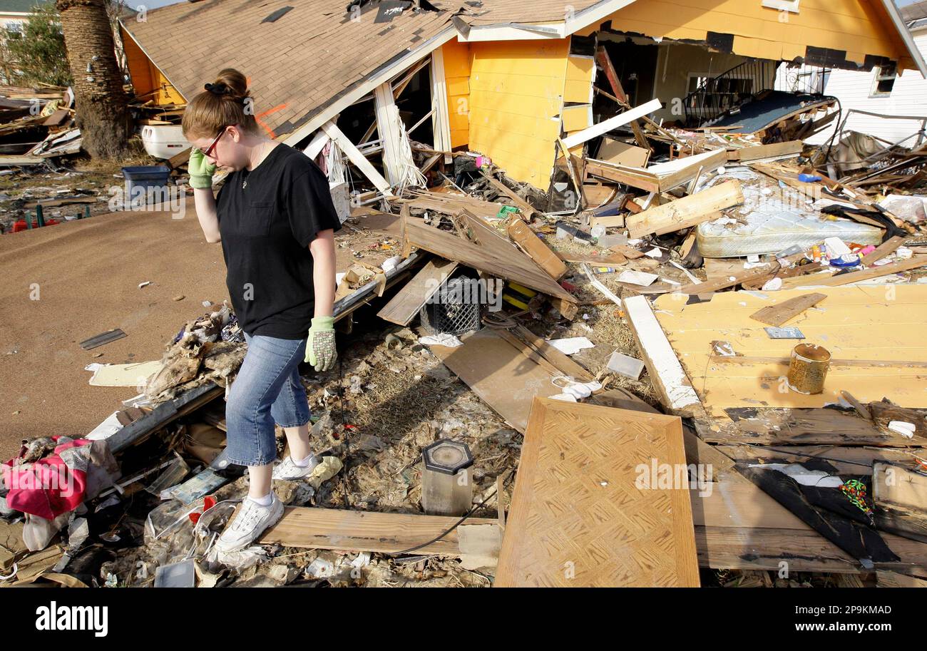 Gina Hadley walks through what's left of her home in the aftermath of ...