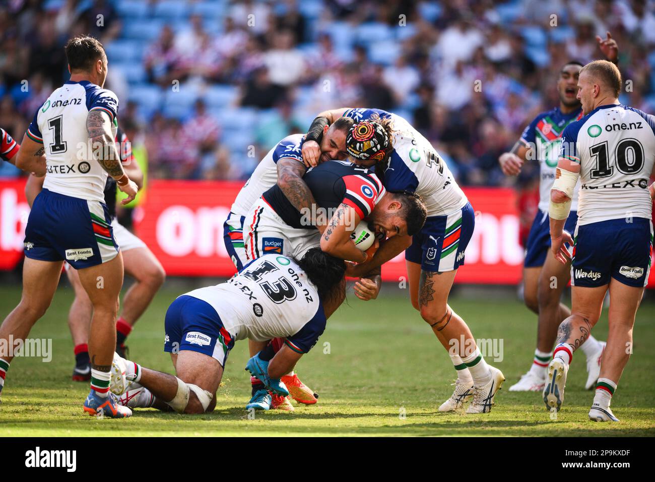 Terrell May of the Roosters is tackled by Dylan Walker of the Warriors ...