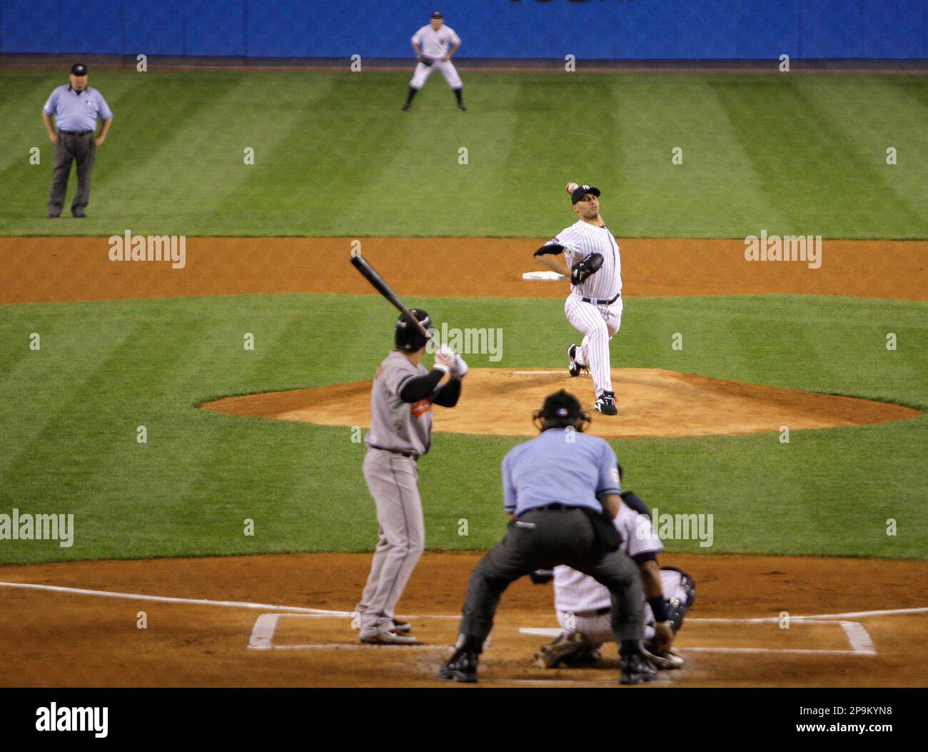 New York Yankees' Andy Pettitte delivers the first pitch of the game to ...