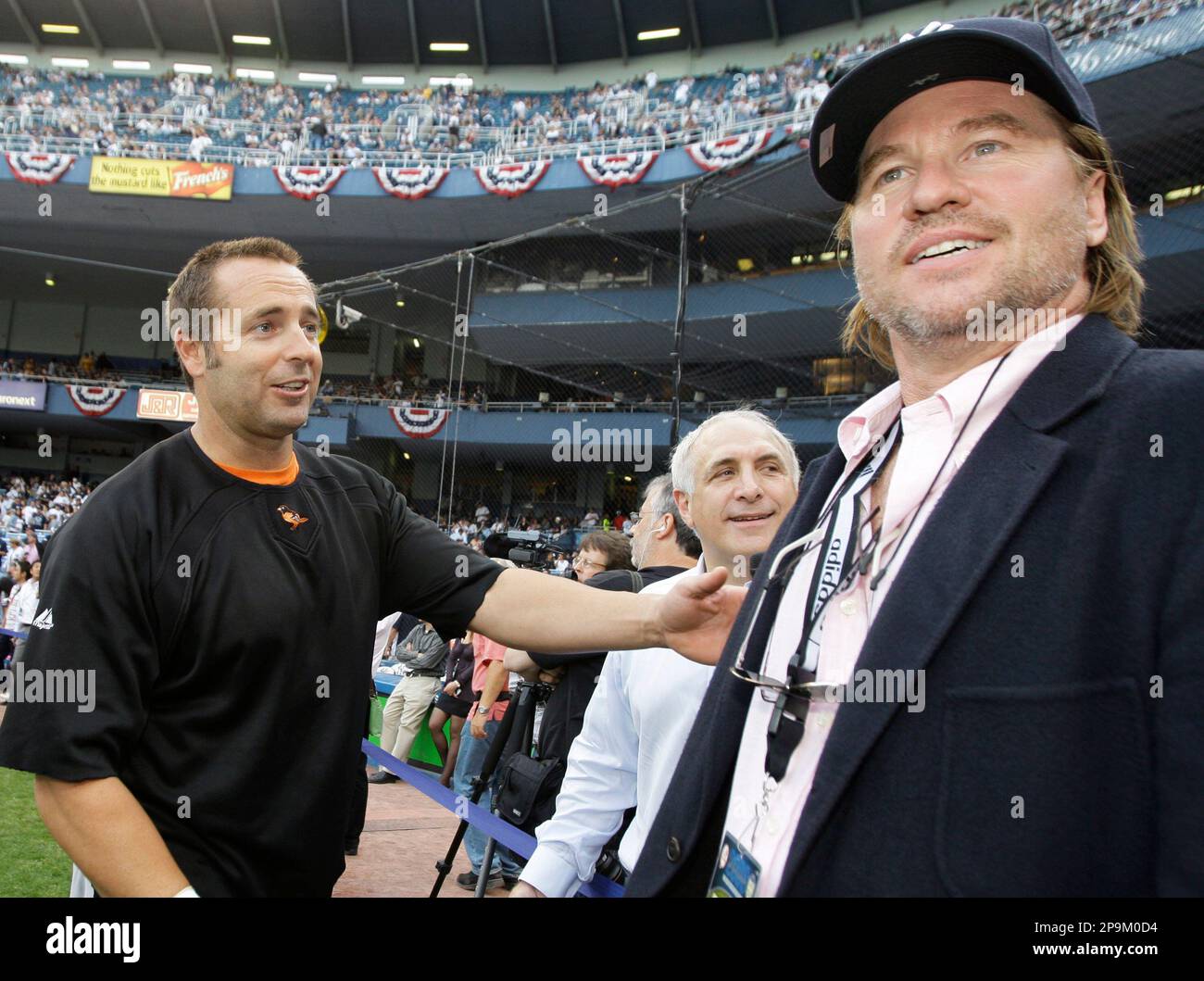 Baltimore Orioles' Kevin Millar, left, talks with actor Val Kilmer ...