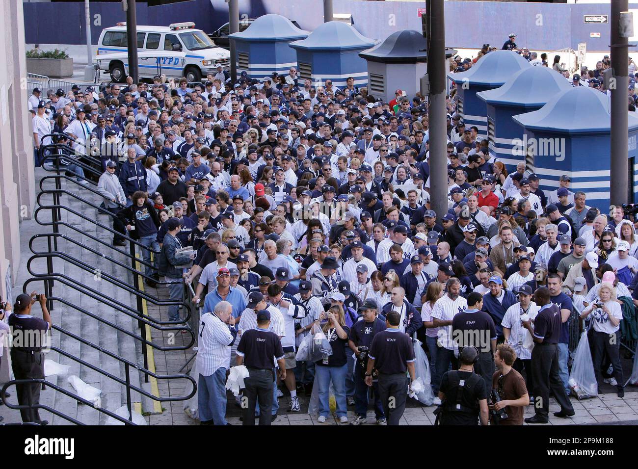 Fans crowd outside Gate 2 waiting to be let into Yankee Stadium to tour ...