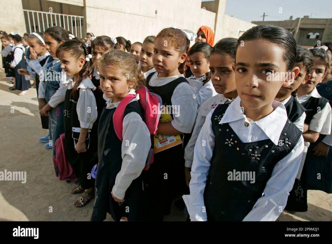 Iraqi girls line up at their school in the Shiite stronghold of Sadr ...