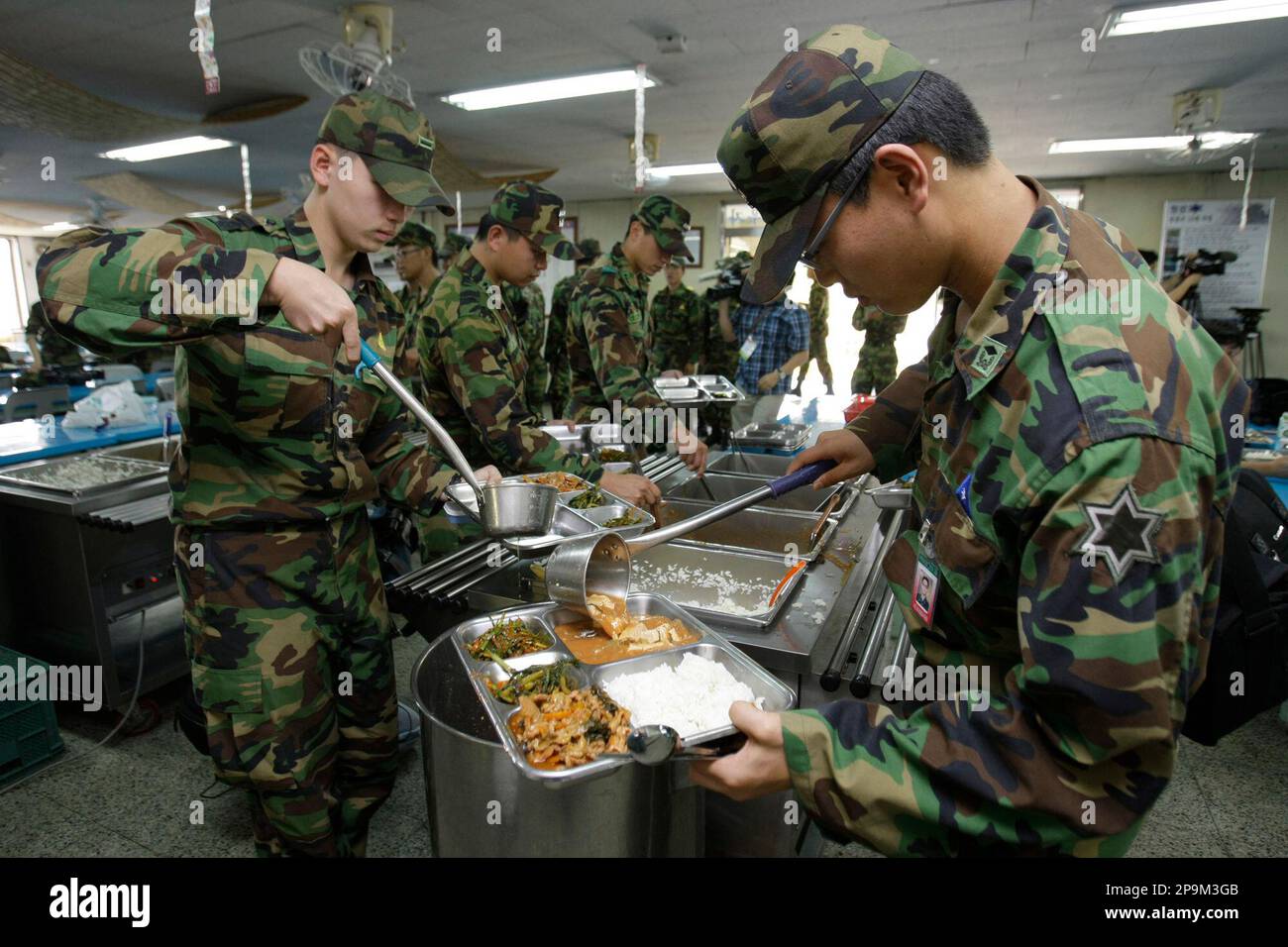 South Korean soldiers distribute food for lunch at their military ...