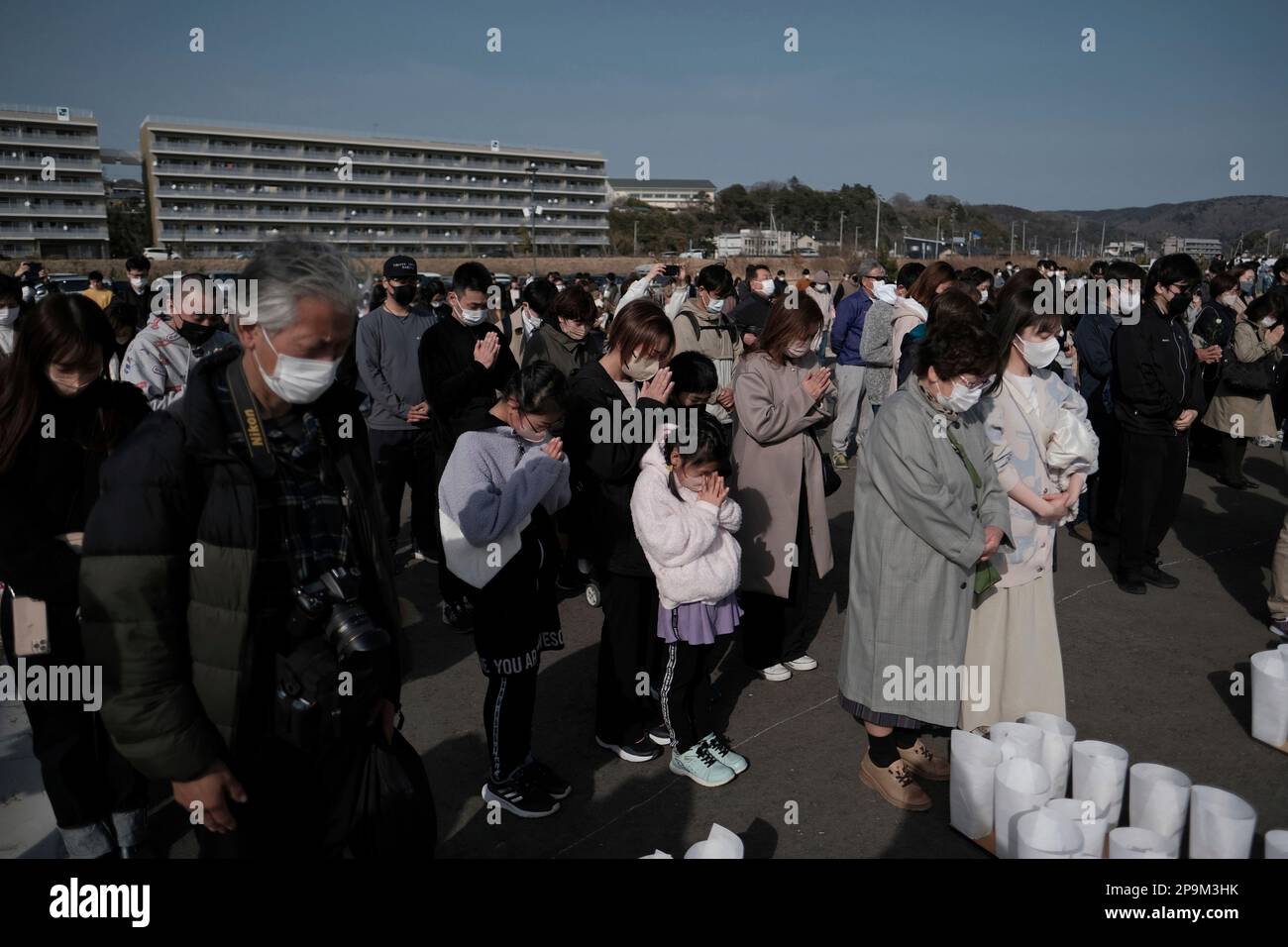People offer silent prayers for the victims of the 2011 Great East Japan Earthquake and Tsunami ...