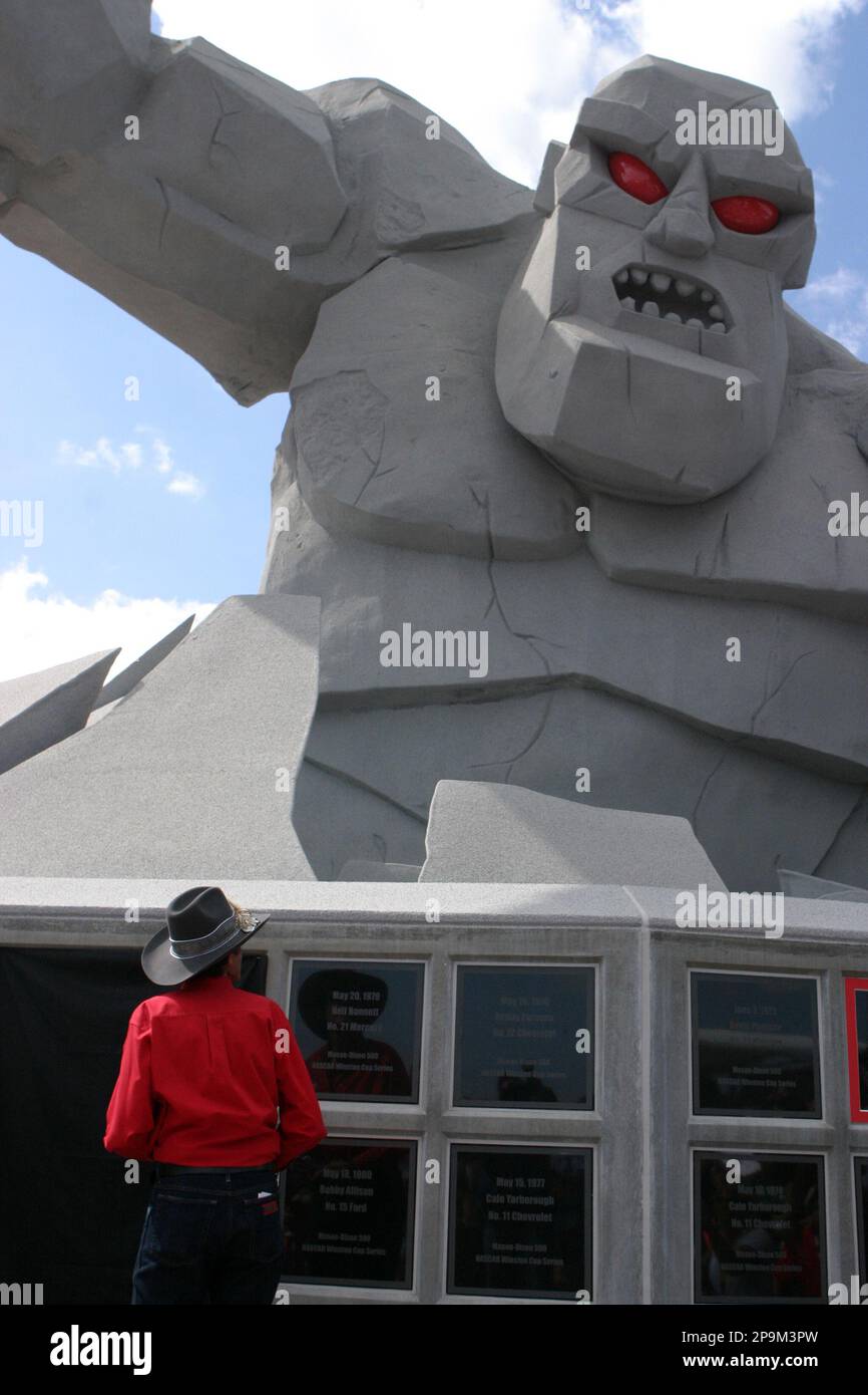 Seven-time NASCAR champion Richard Petty looks up at a huge statue of ...