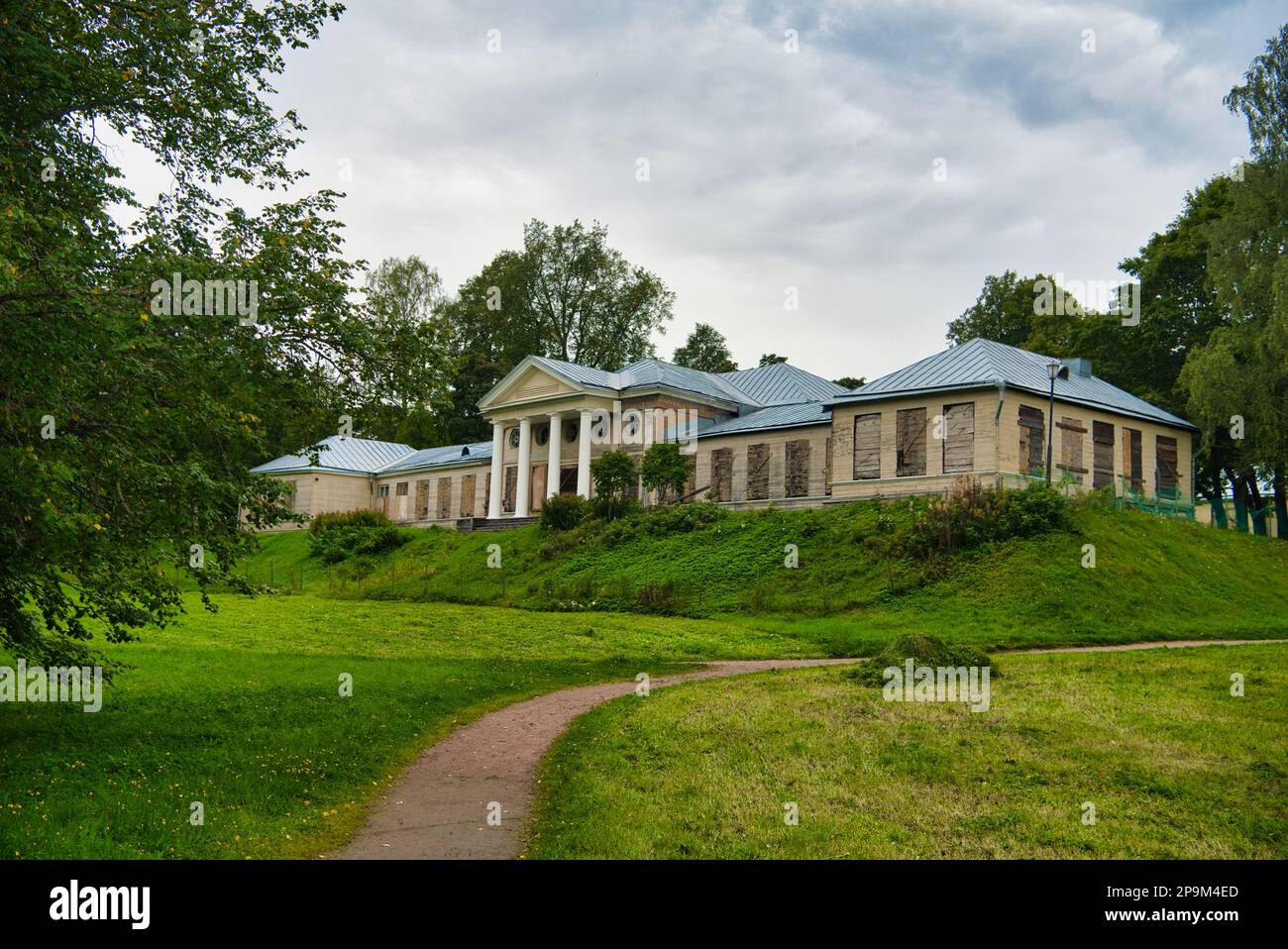 Green meadow and ruins of estate in Park Mon Repos, Vyborg, Russia ...