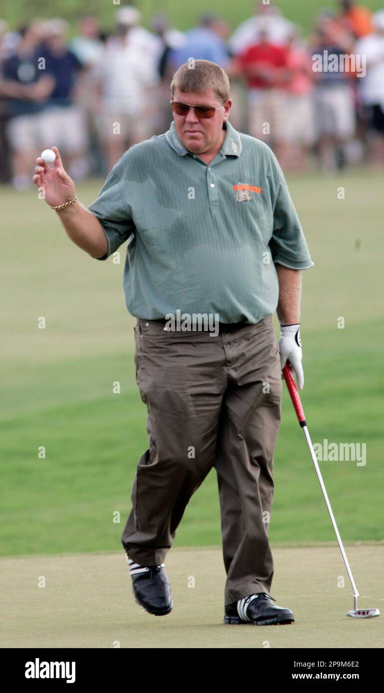 John Daly waves to the crowd after making birdie on the 18th hole ...