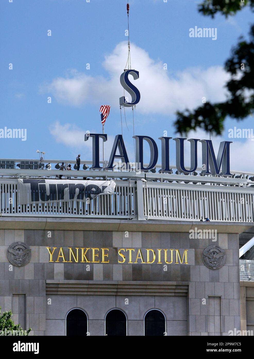 A giant letter S is lowered into place to complete the word "Stadium ...