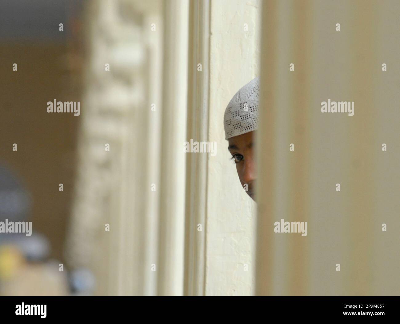 A Muslim boy looks on after offering Friday prayers during the Islamic ...