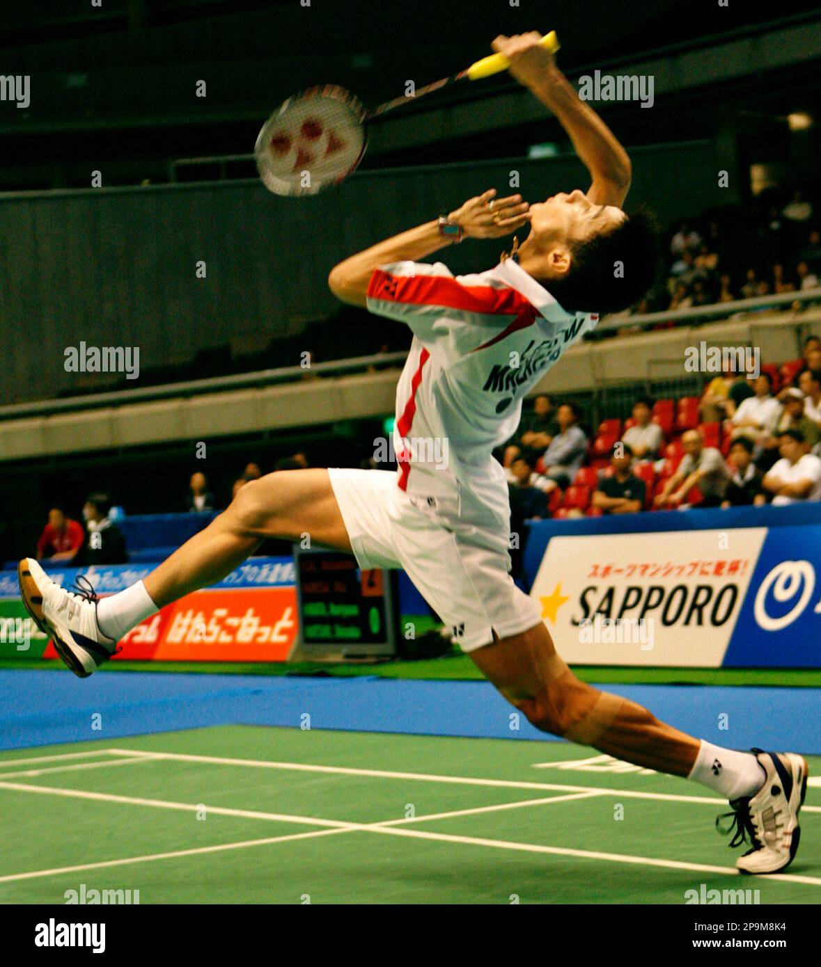 Malaysia's Lee Chong Wei goes after a return shot against China's Qiu Yanbo during Yonex Open ...