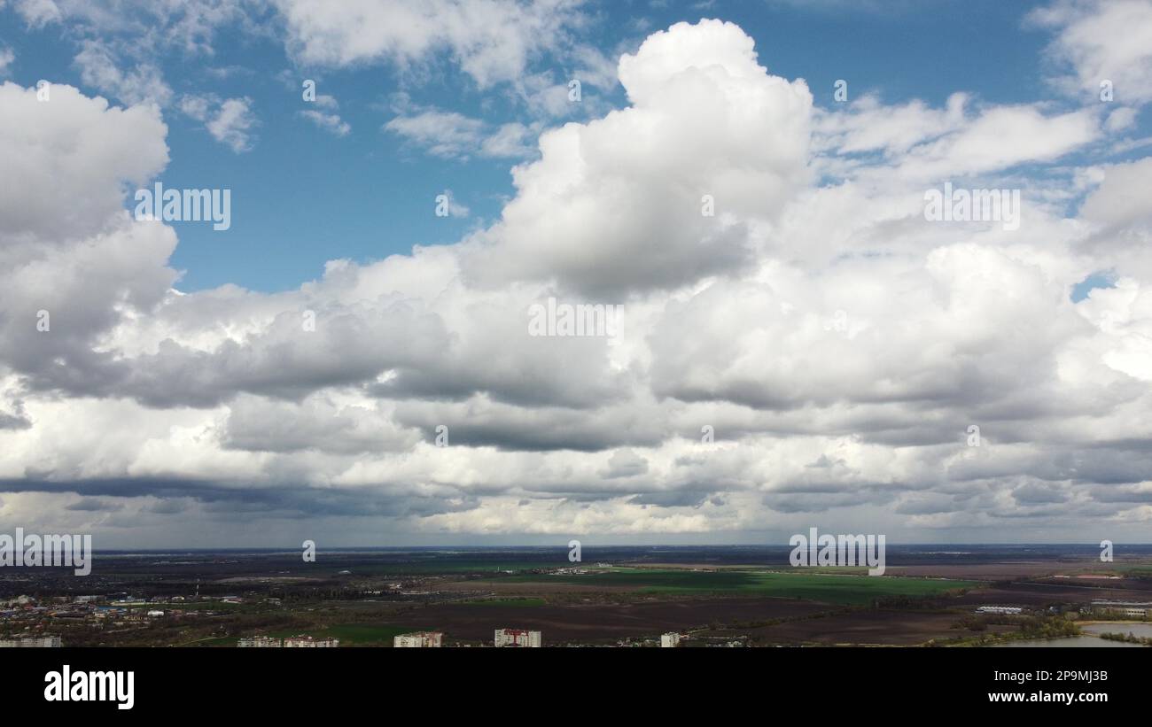 Movement of white cumulus clouds in blue sky, wind on day. Aerial drone ...