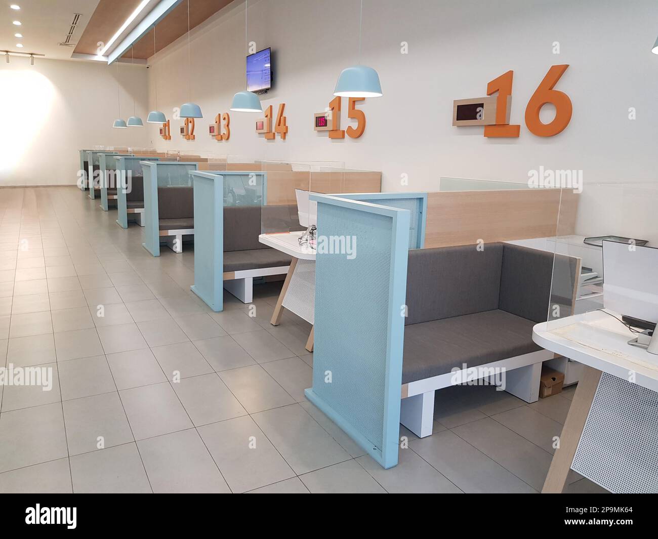 Empty bank countier with sofa and cabine numbers Stock Photo - Alamy