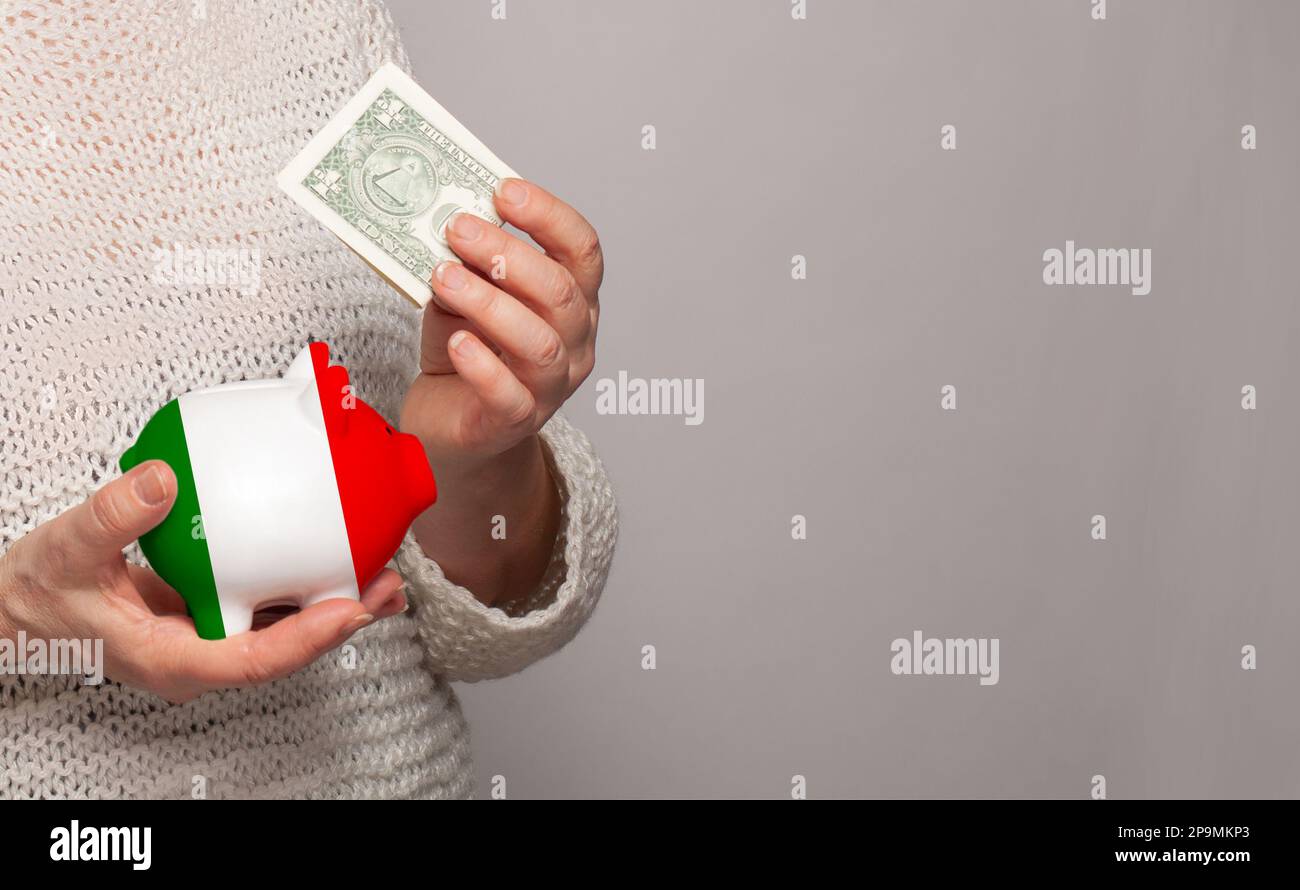 Flag of Italy on money bank in Italian woman hands. Dotations, pension ...