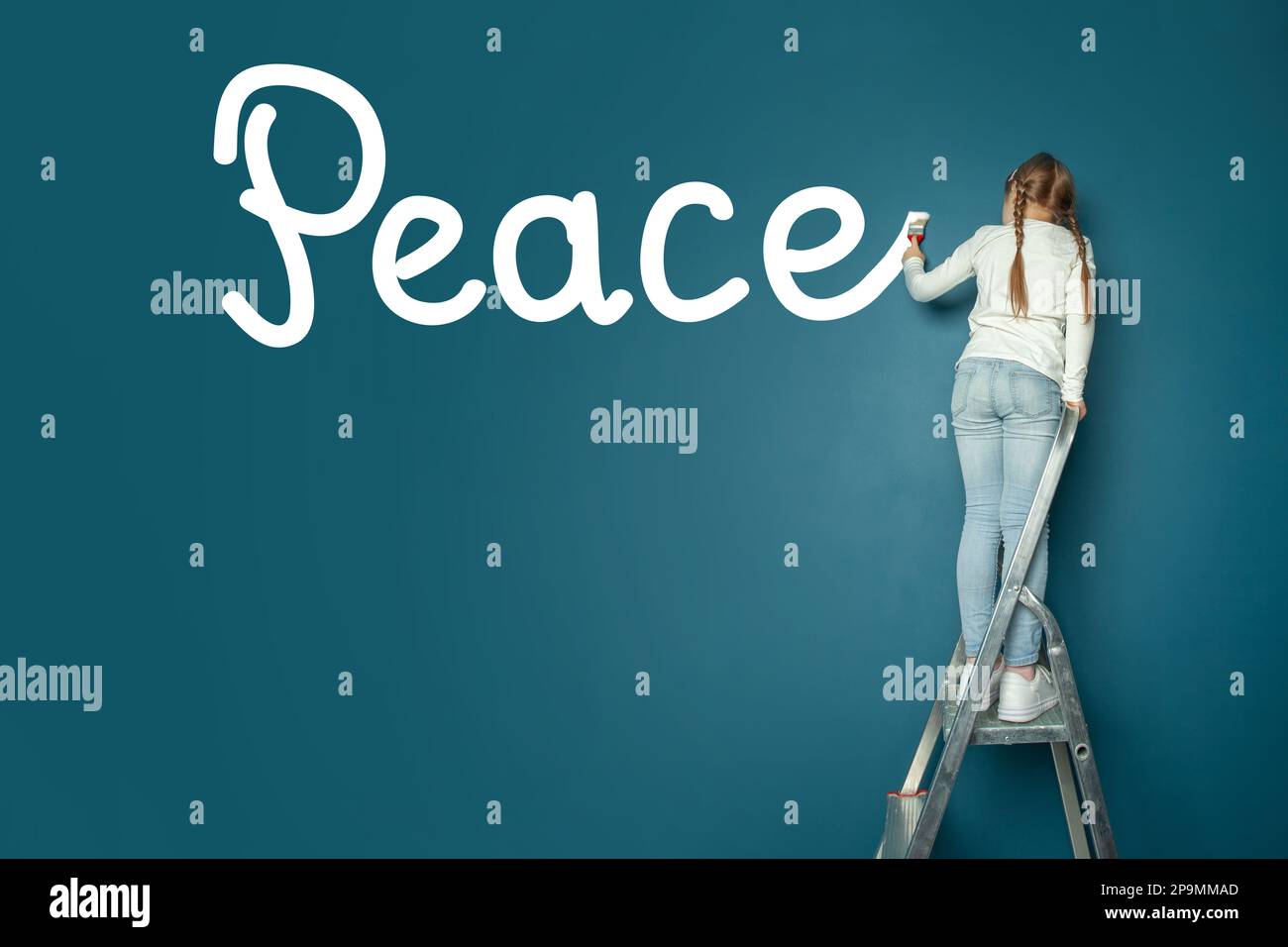 Child girl on ladder writing word Peace on the wall with brush. Social ...