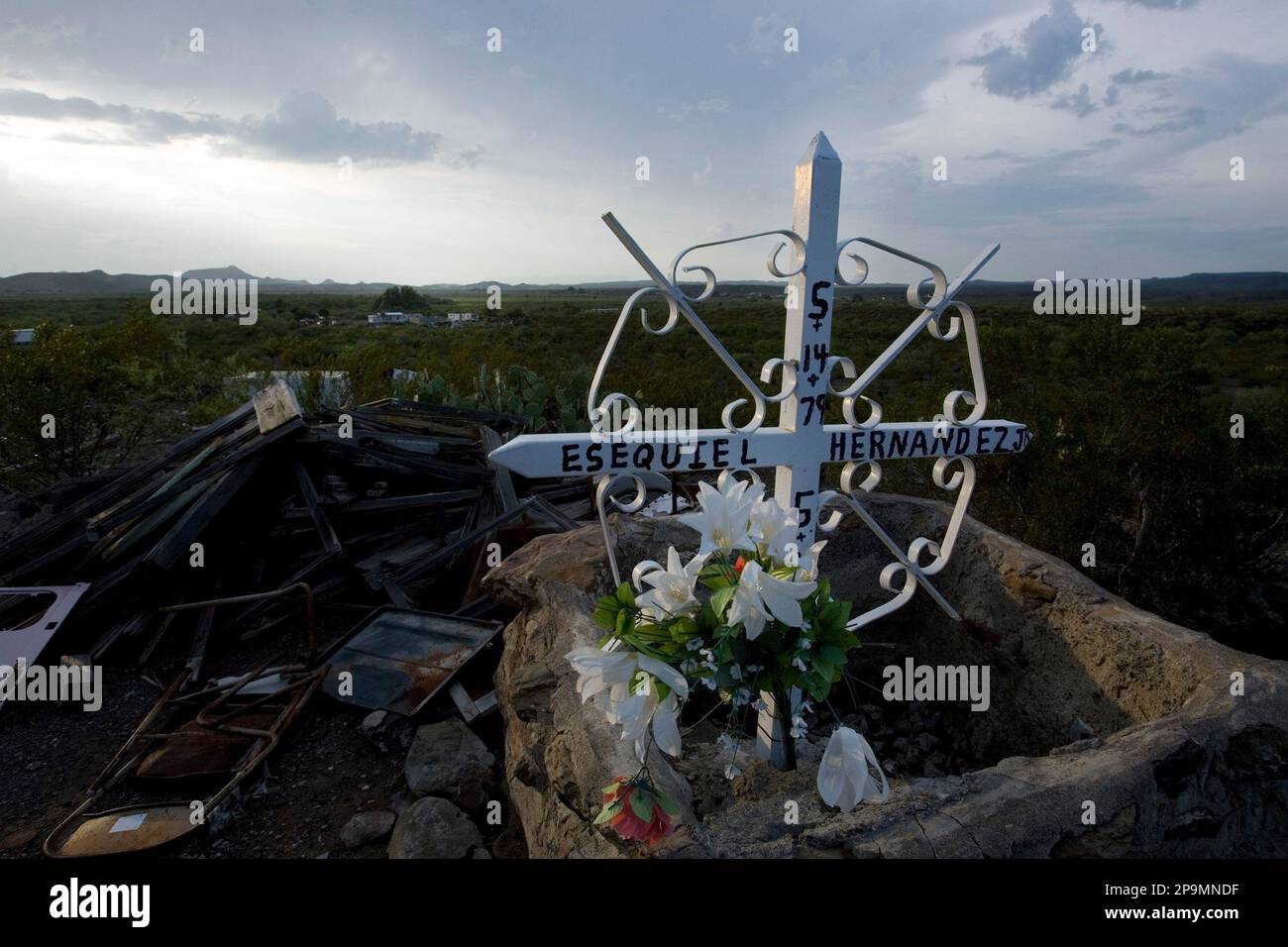 A cross honoring Esequiel Hernandez, Jr. sits on the place he fell dead ...