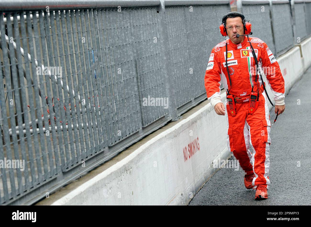Ferrari team manager Luca Baldisseri walks towards the pits prior to ...