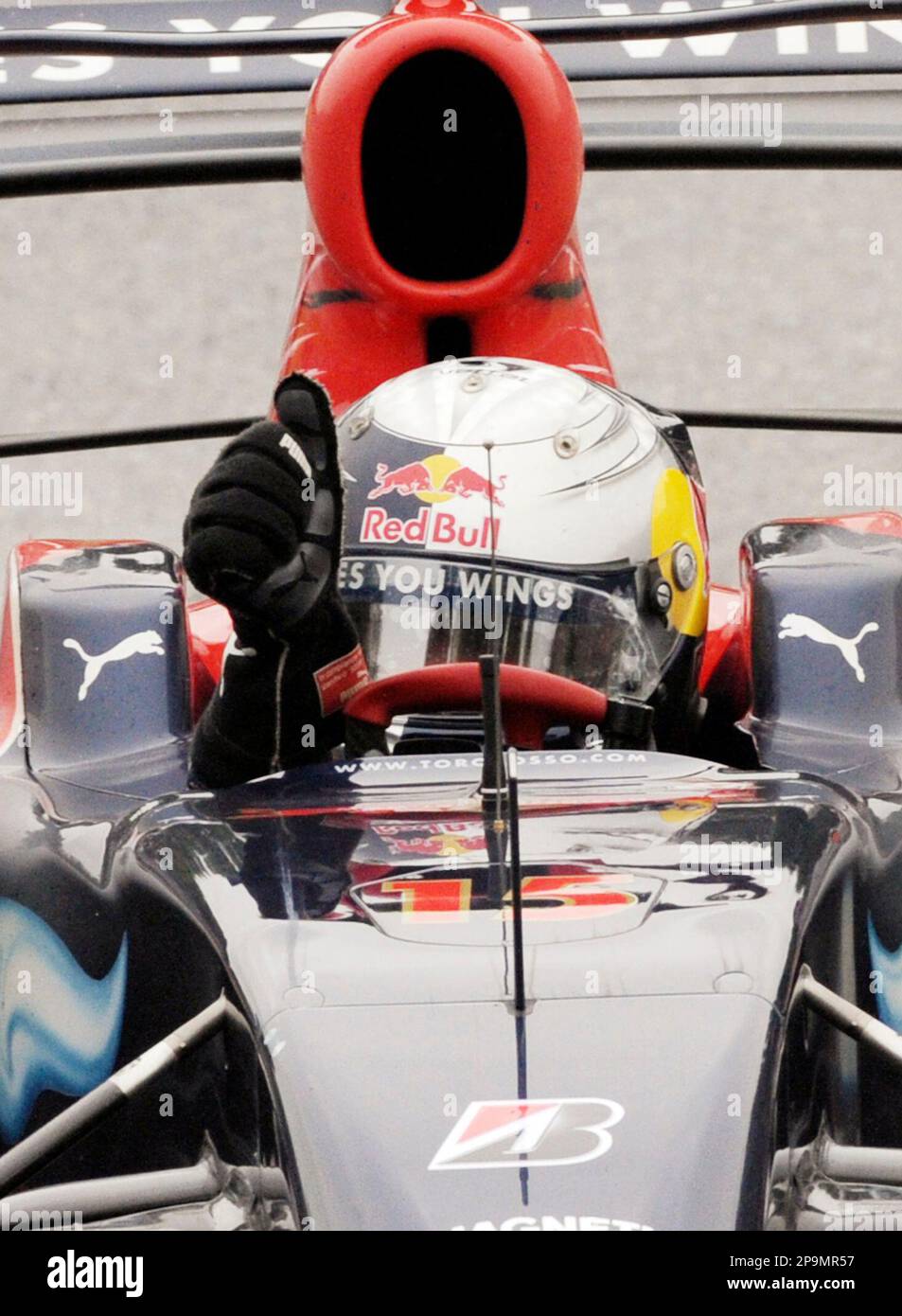 Toro Rosso driver Sebastian Vettel of Germany gives the thumb-up sign ...