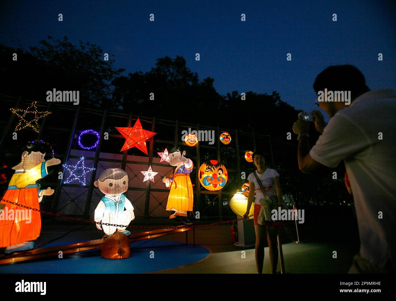 Visitors take pictures in front of lanterns displayed at Hong Kong's ...