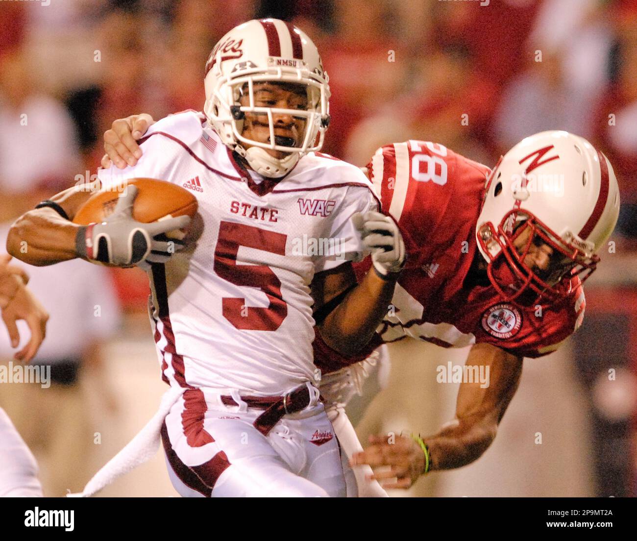 New Mexico State's Julius Fleming (5) is tackled by Nebraska's Eric ...
