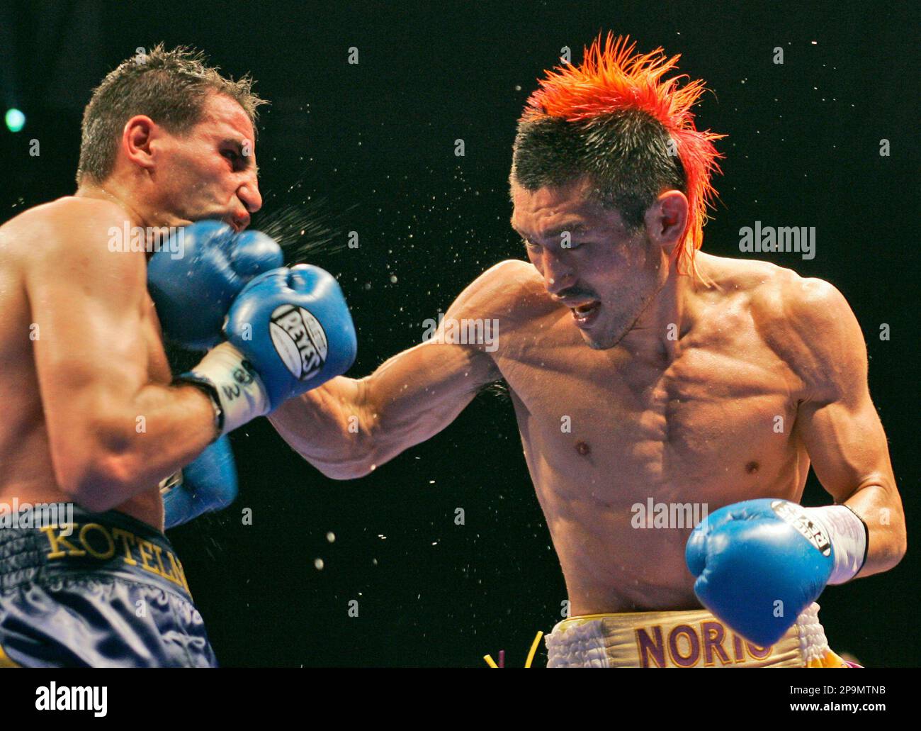 Norio Kimura of Japan right, throws a punch at WBA Light Welterweight champion Andreas Kotelnik ...