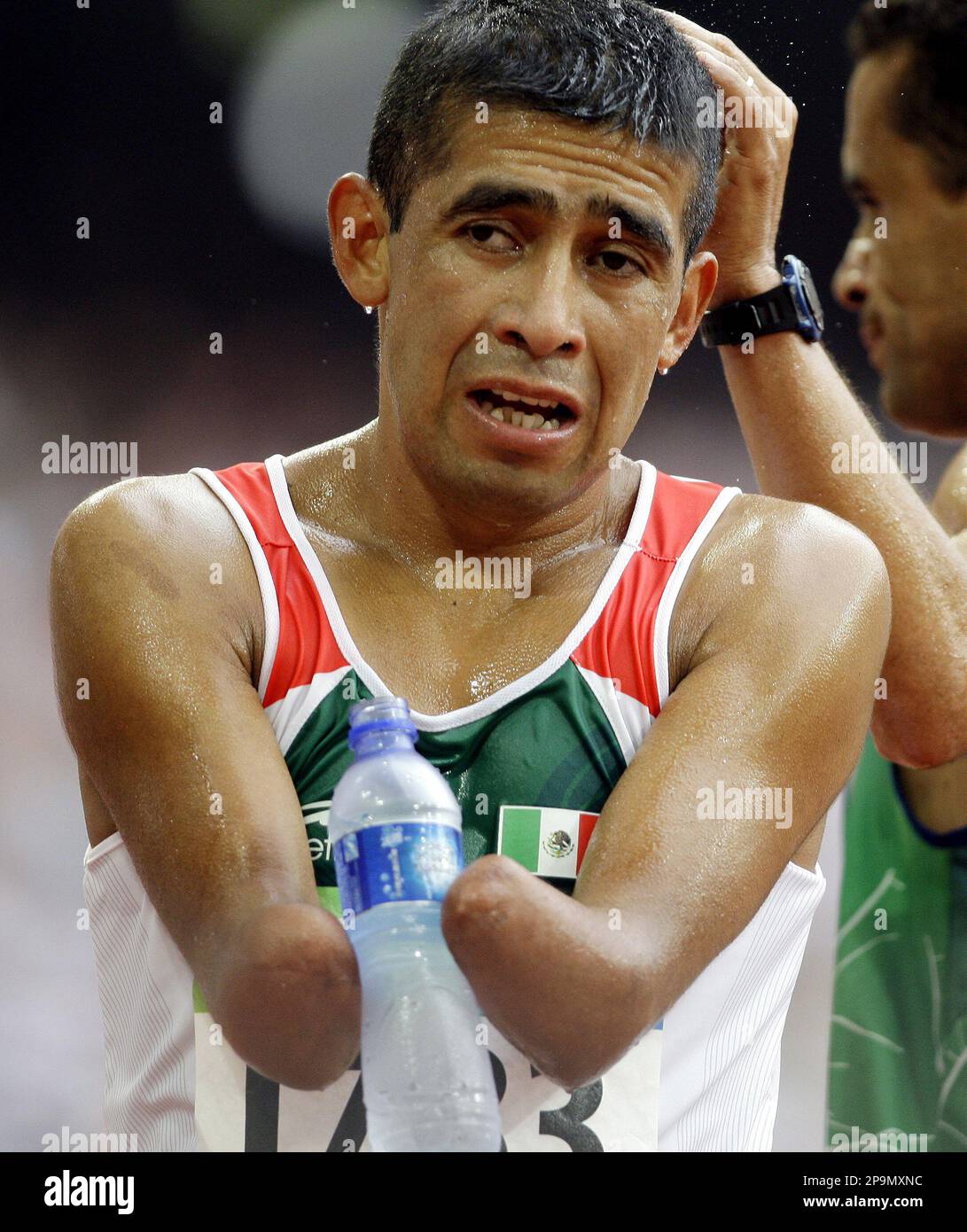 Mexico's Pedro Meza holds a water bottle after competing in the men's ...