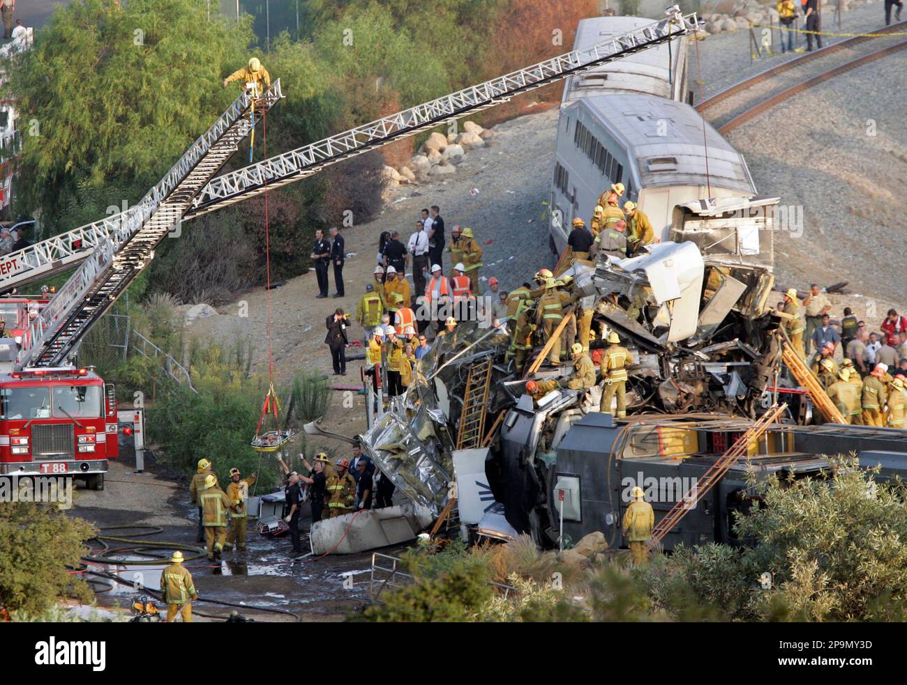 Rescuers remove a victim with a gurney attached to an aerial ladder as ...
