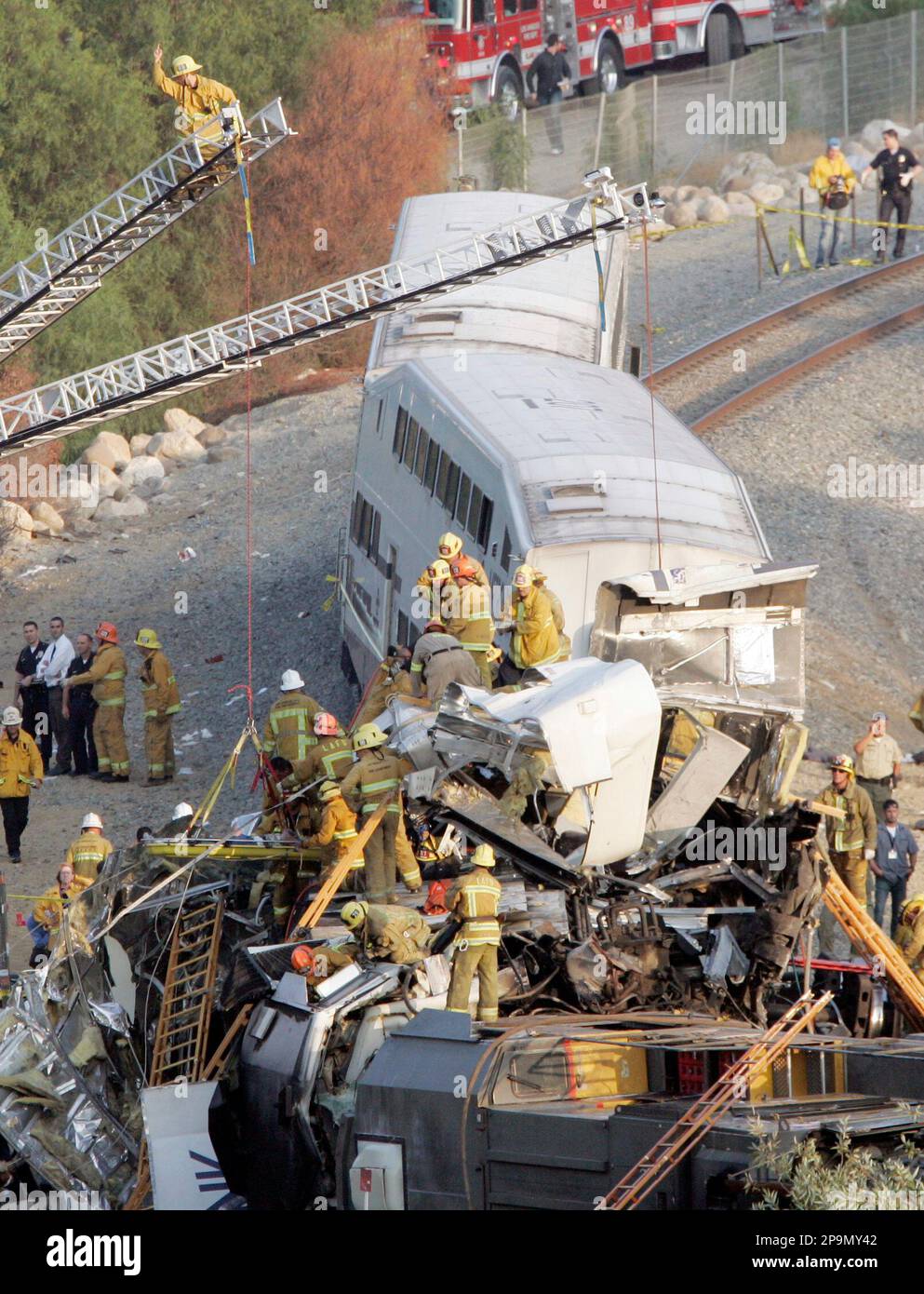 Rescuers remove a victim with a gurney attached to an aerial ladder as ...