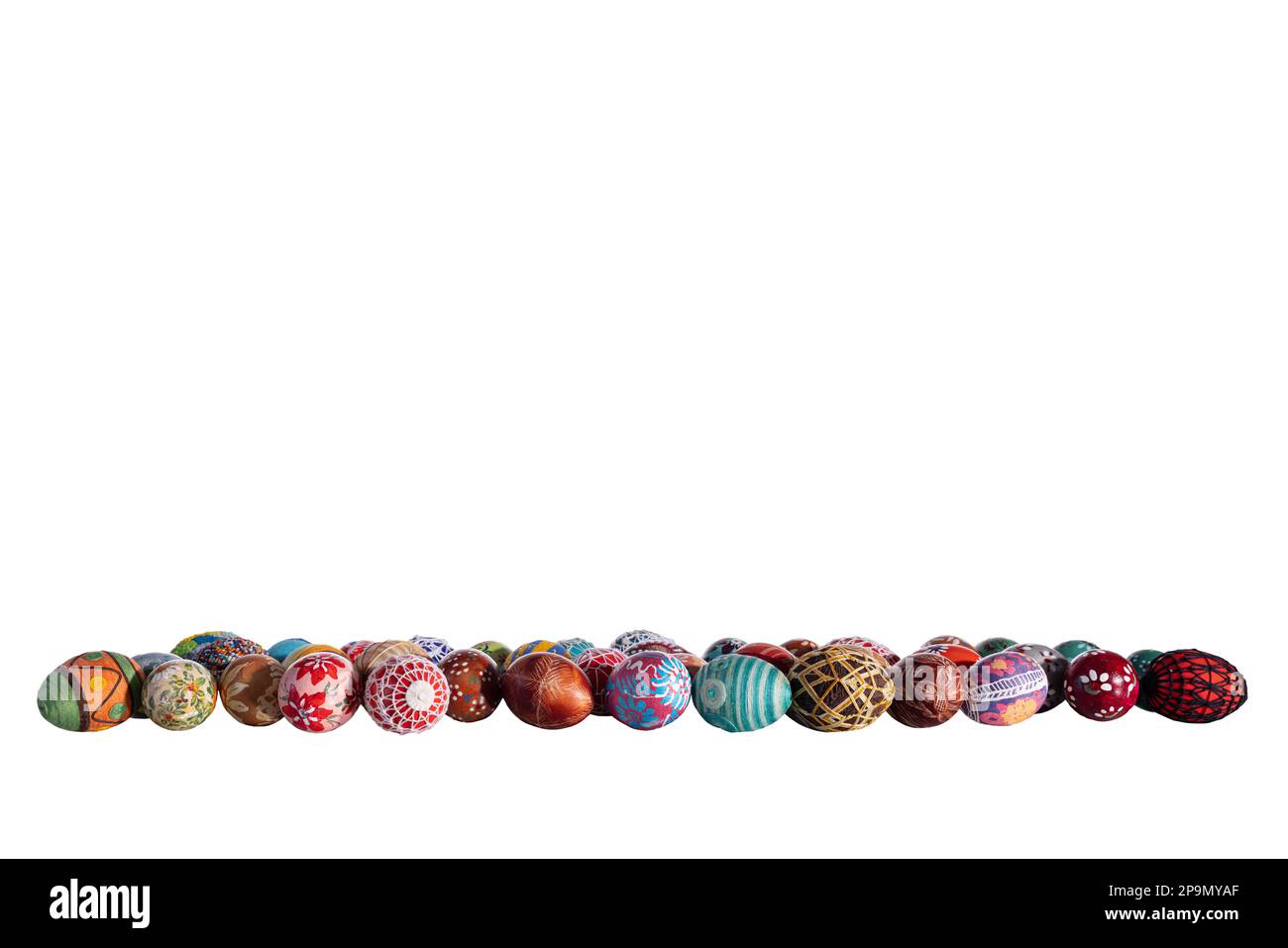 Different colors and patterns of Easter eggs lined up in a row on a ...