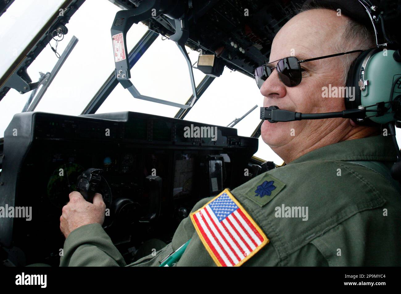 Pilot Lt. Col. Mark Carter speaks to other crew via his headset as he ...