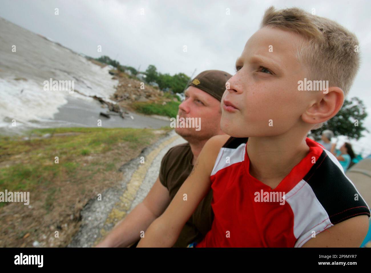 Jacob Morgan, right, and his father Russelll wait for the approaching ...