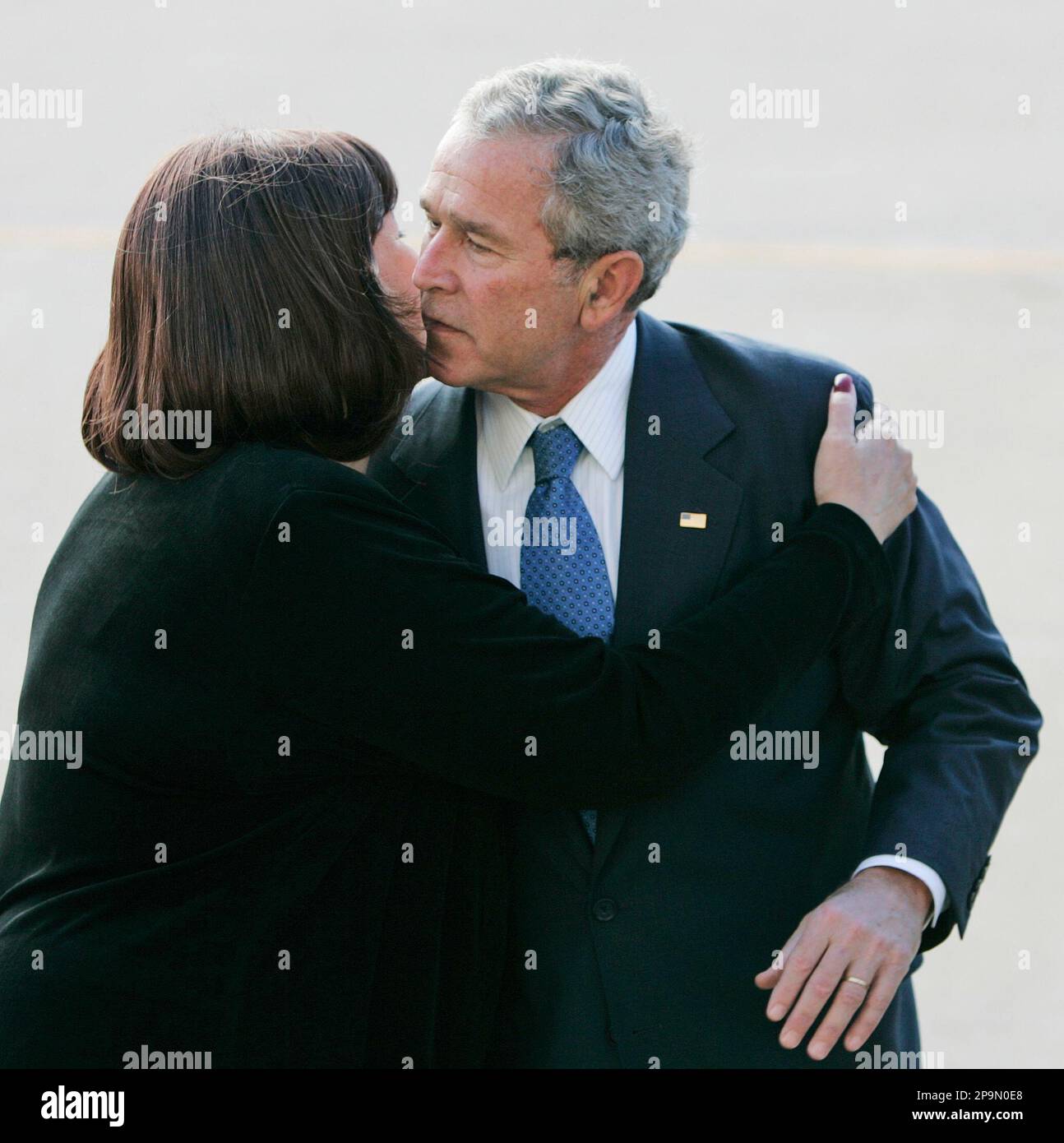 President Bush gets a hug from Karen Stark of Edmond, Okla., Friday ...